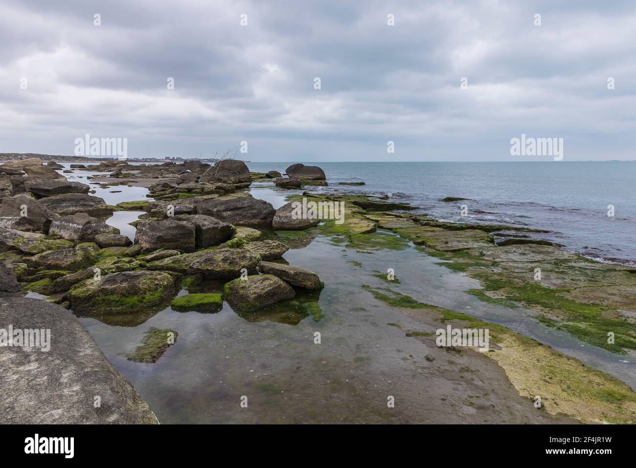 Boulders of rocks lying on the coast after the shallowing of the sea ...