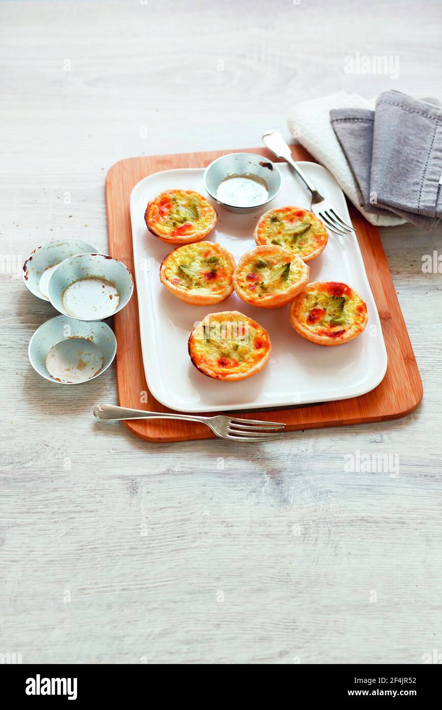 Little quiche with roman cabbage and brie cheese Stock Photo - Alamy