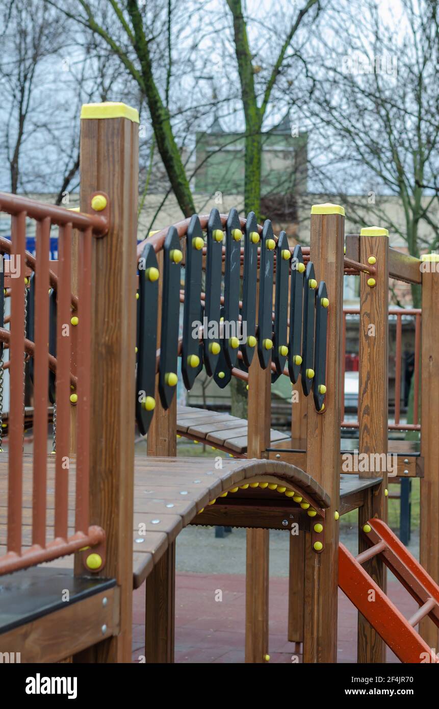 Empty children's playground after the rain. Wet swing among puddles ...