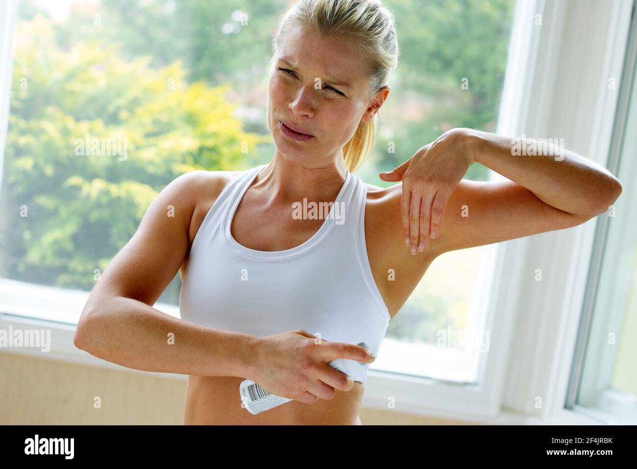 Young girl applying deodorant Stock Photo - Alamy