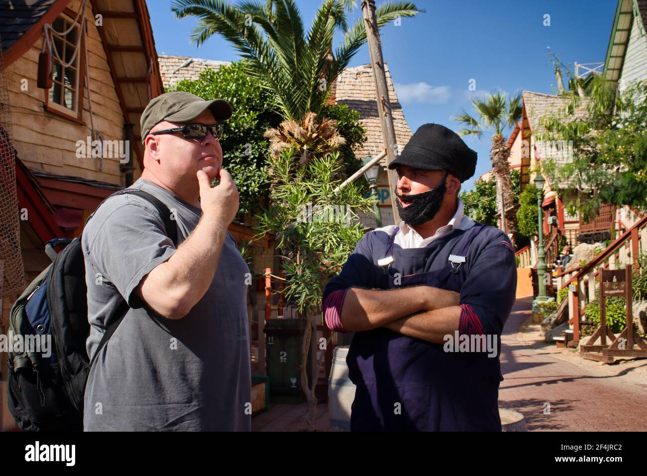 Actor playing Bluto on the set of the Popeye movie talking to a tourist ...