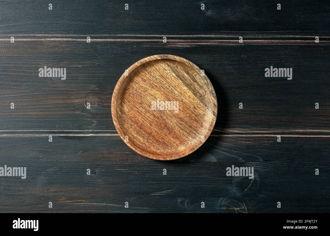 empty wooden plate on dark kitchen table, top view Stock Photo - Alamy
