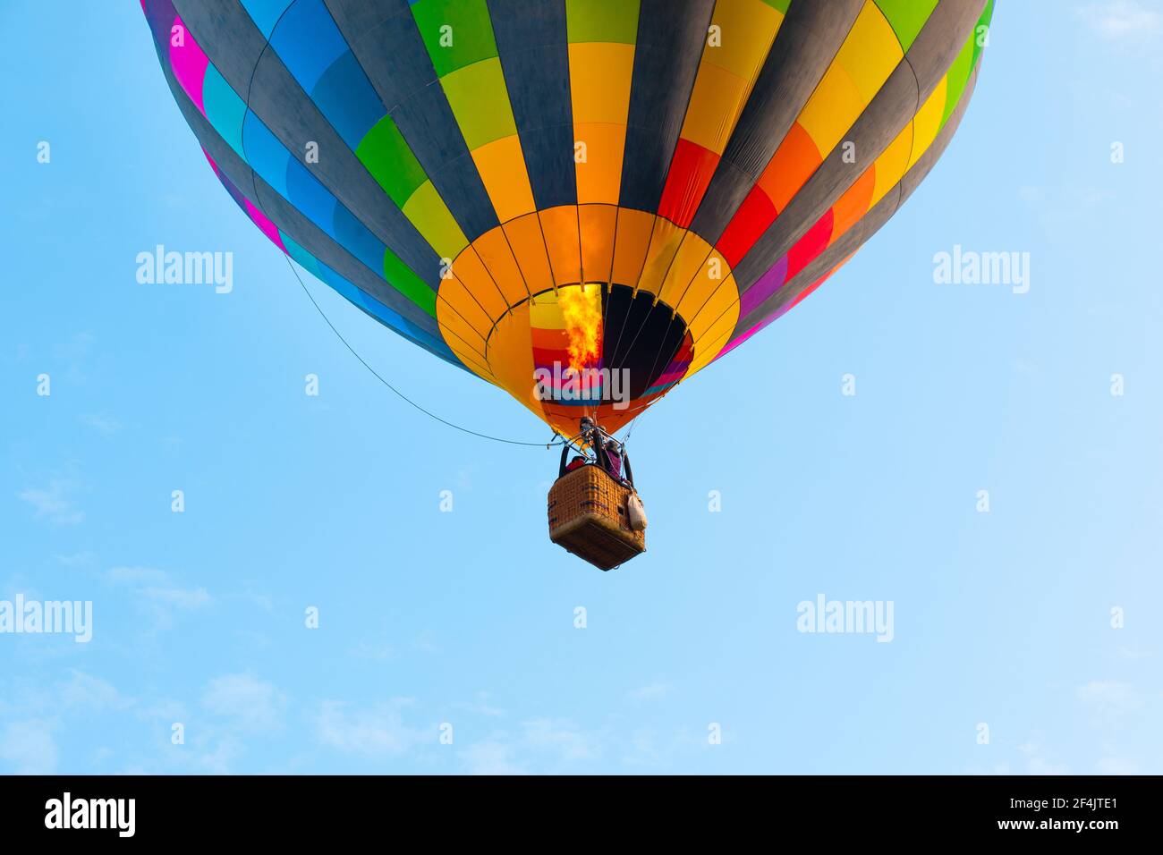 Bright colored beautiful hot air balloon fly on blue sky background of ...