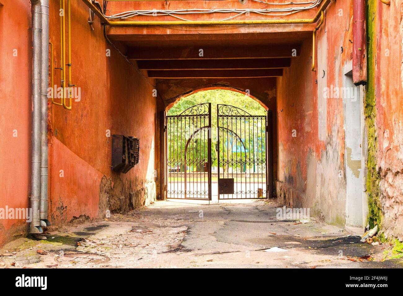 image of a walk-through arch with wrought-iron gates in an old house ...