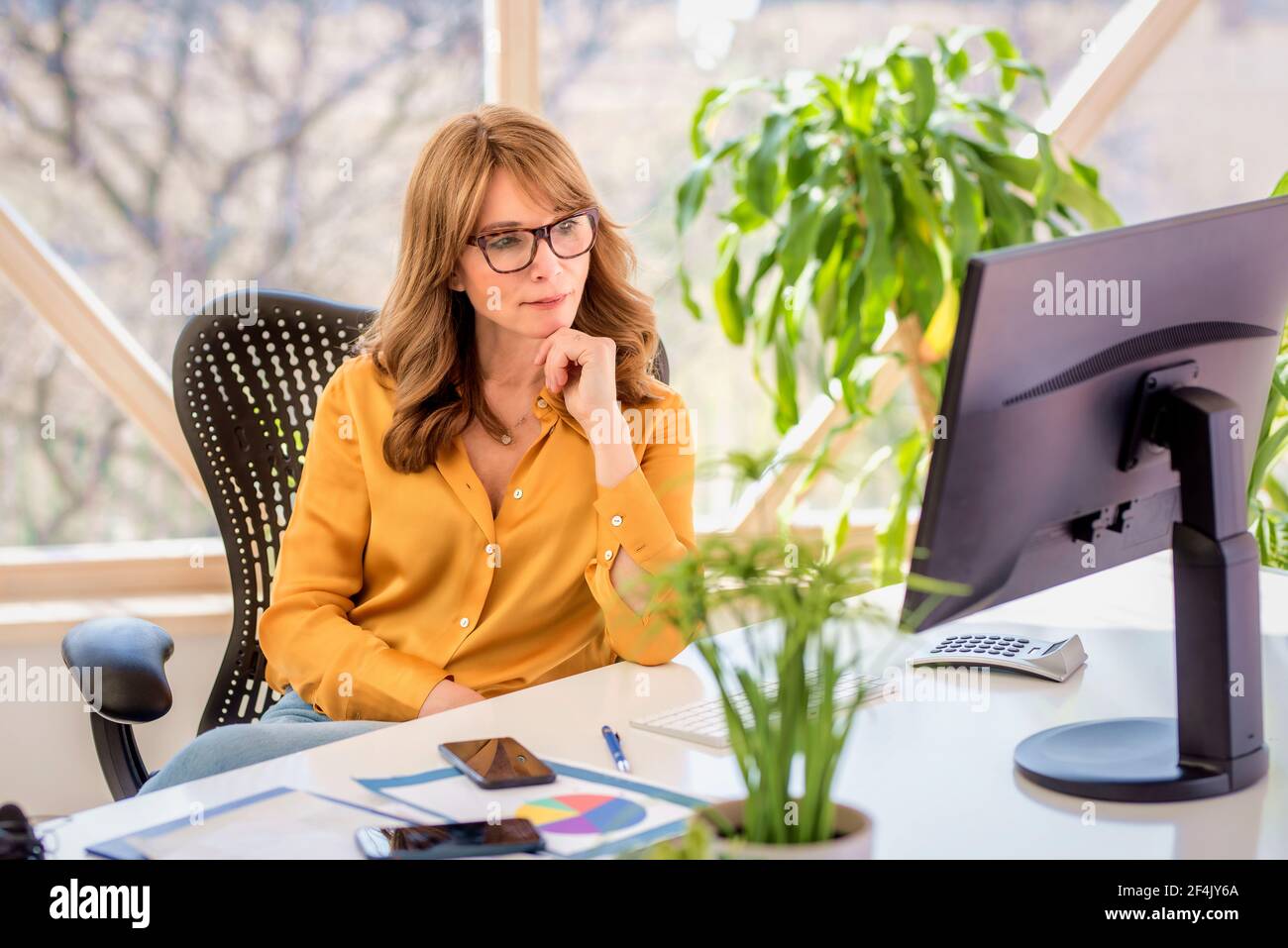 Person deep in thought behind computer hi-res stock photography and ...