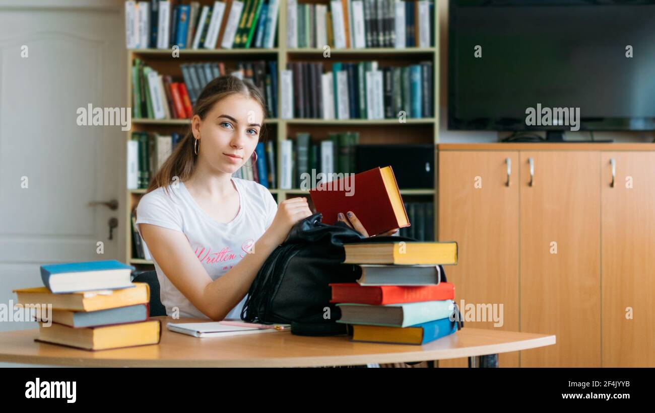 Back to school library concept. Student girl holding book on her head ...