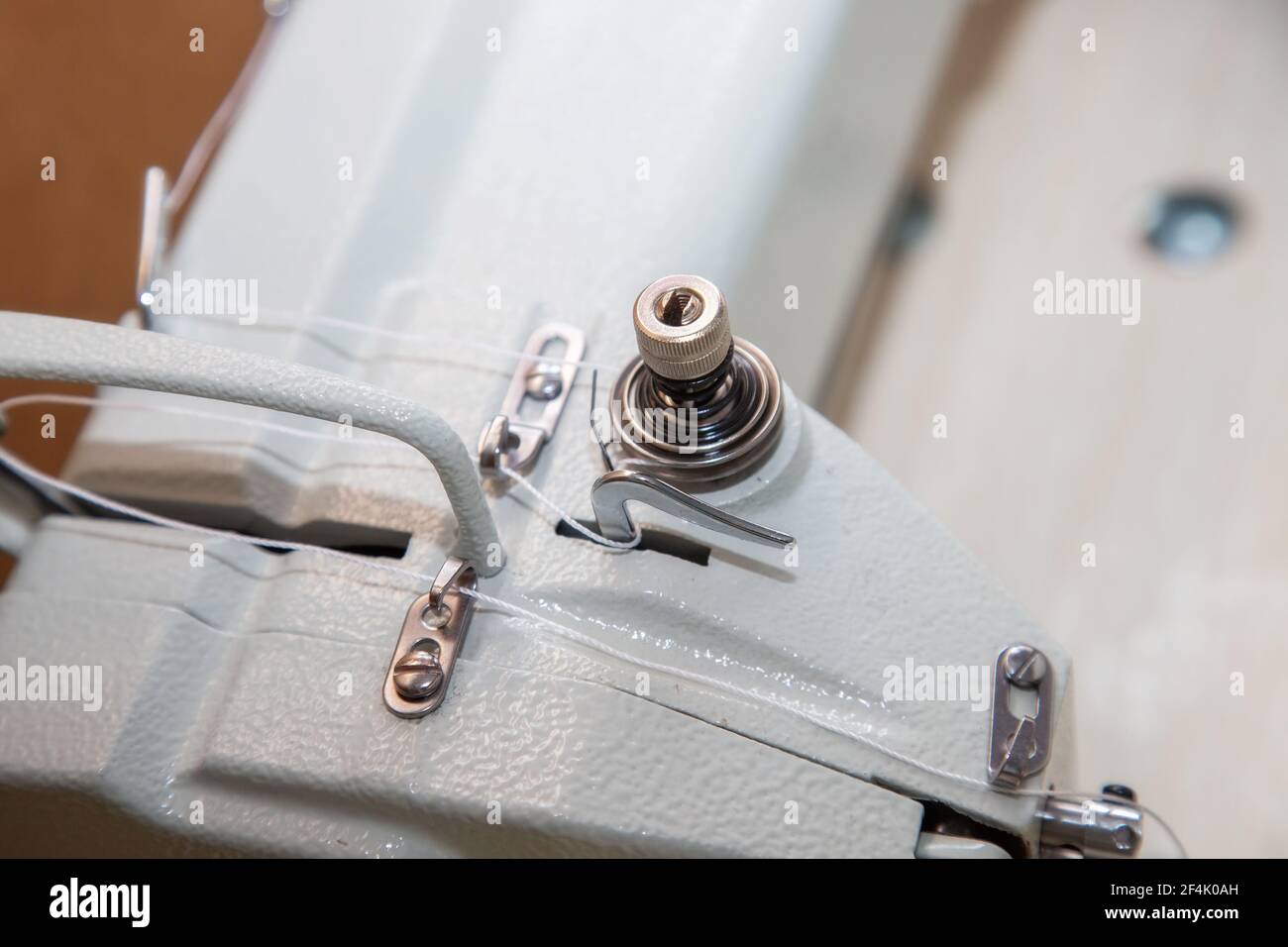 Parts and components of an industrial sewing machine tilted to one side ...