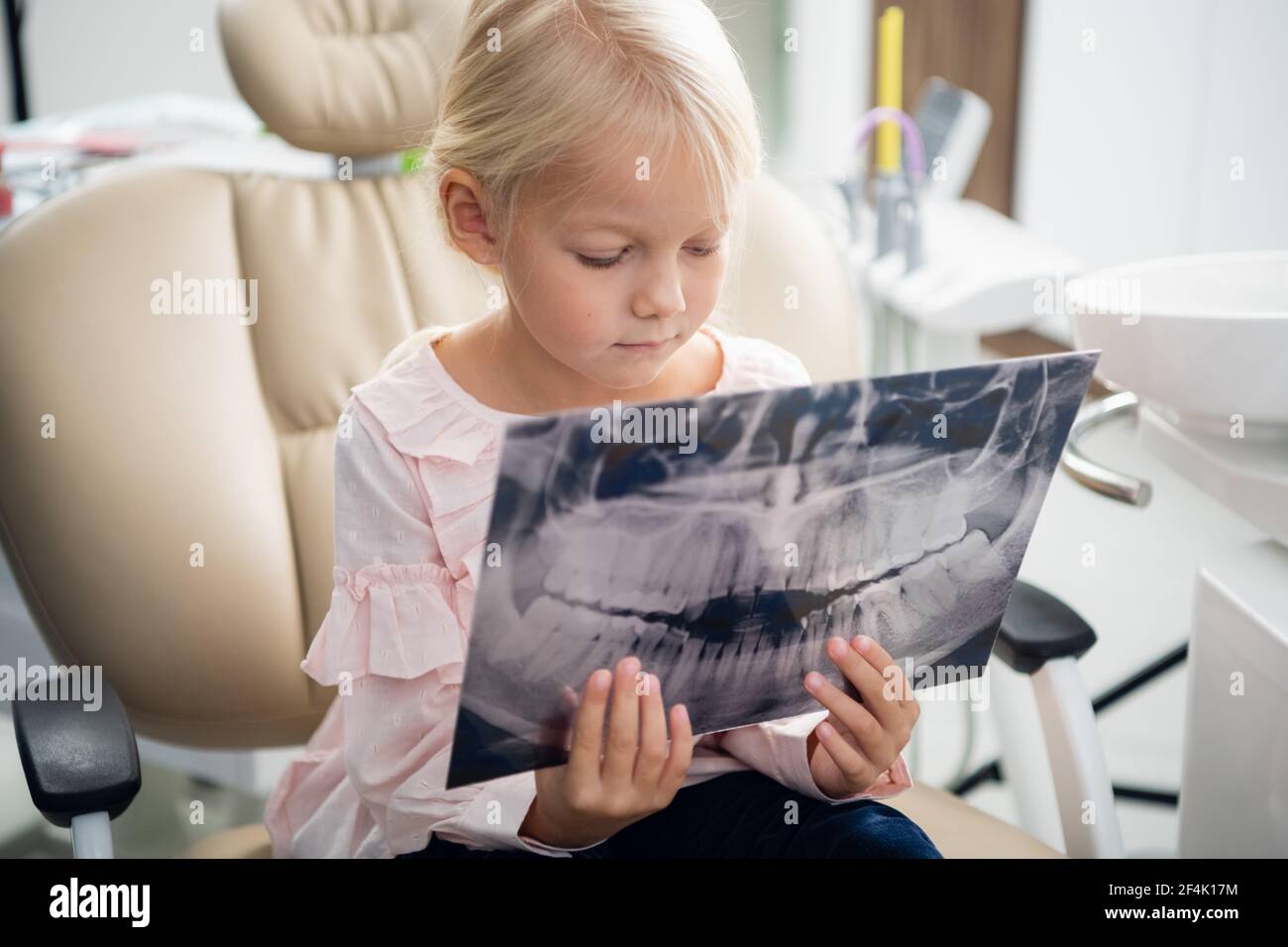 Close up of a cute little female child examining an x-ray of a j Stock ...