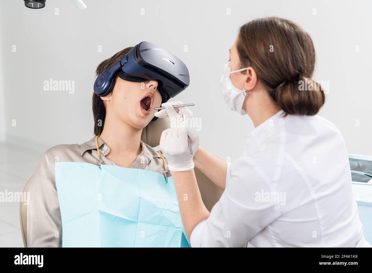 A procedure of drilling a tooth, setting a temporary seal Stock Photo ...