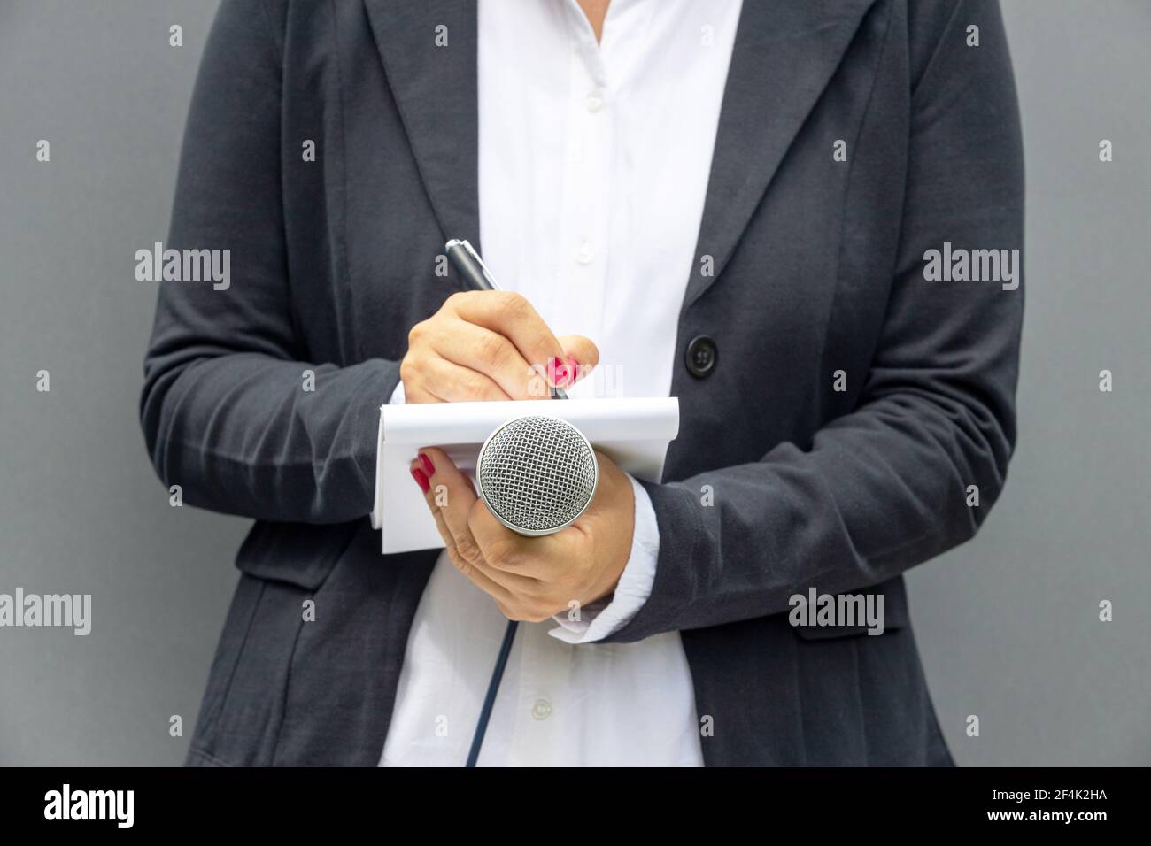 Public relations - PR officer at publicity event holding microphone ...