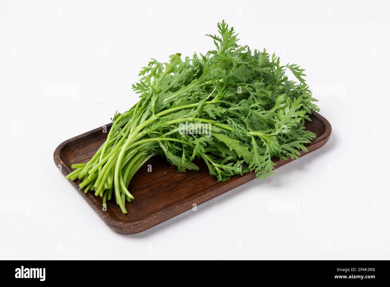 Bunch of fresh chinese mugwort on a wooden tray isolated on white ...