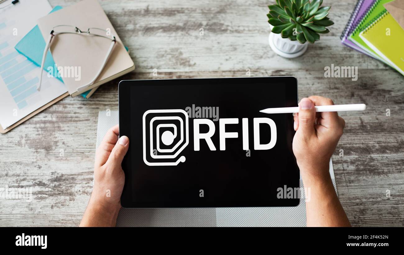 RFID Radio frequency identification technology concept on device screen ...