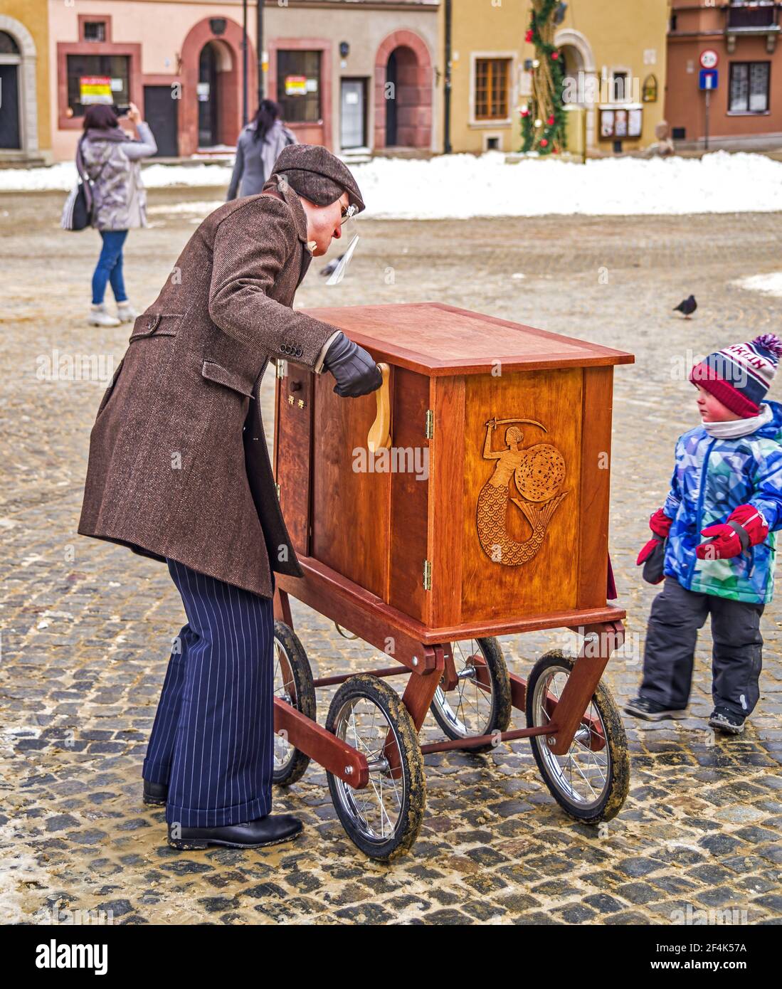 An organ grinder performs in the New Town Market Square - Old Town ...