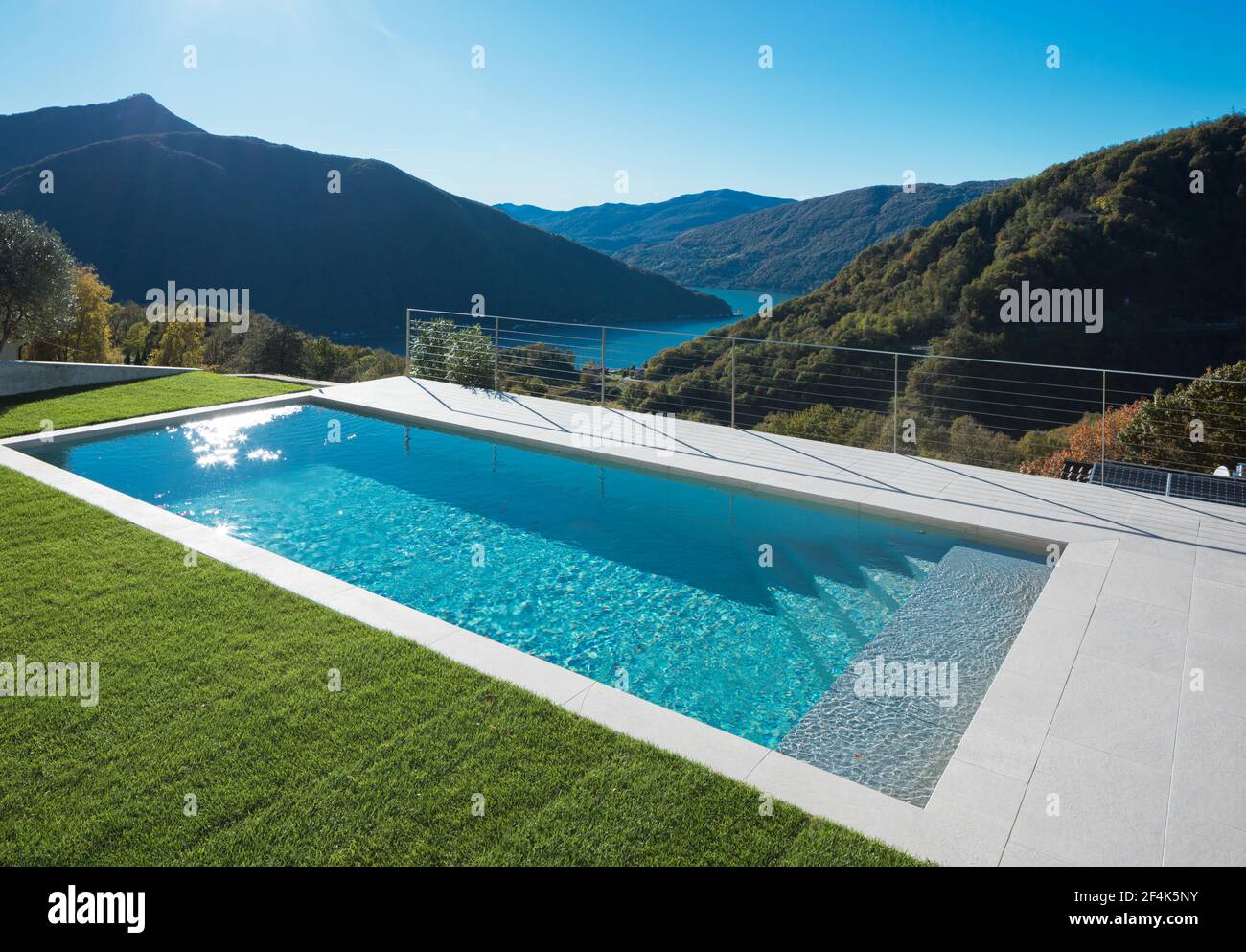 Swimming pool with lake and valley view Stock Photo - Alamy