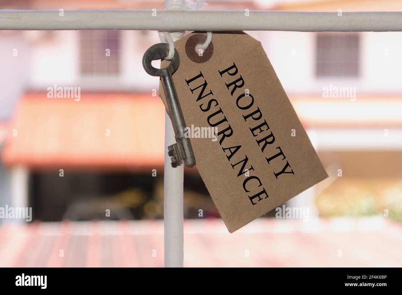 Text on brown paper and key hanging on the window grill with blurred ...