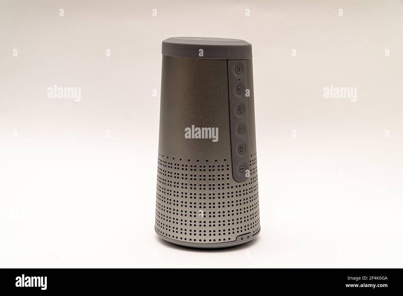 elongated cylinder-shaped speaker on a white background with bluetooth ...