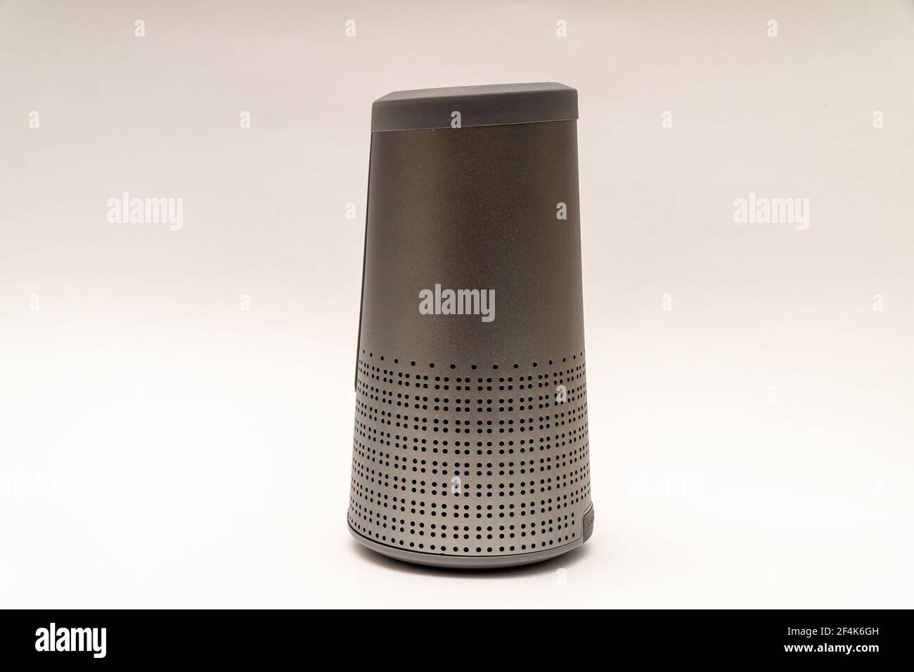 elongated cylinder-shaped speaker on a white background with bluetooth ...