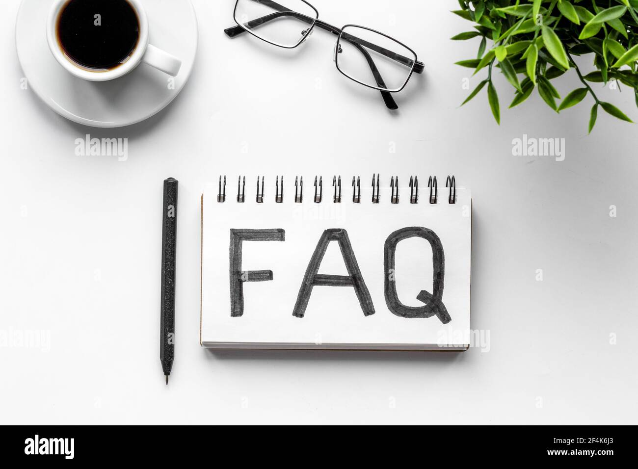 FAQ on office desk. Working with clients concept Stock Photo - Alamy