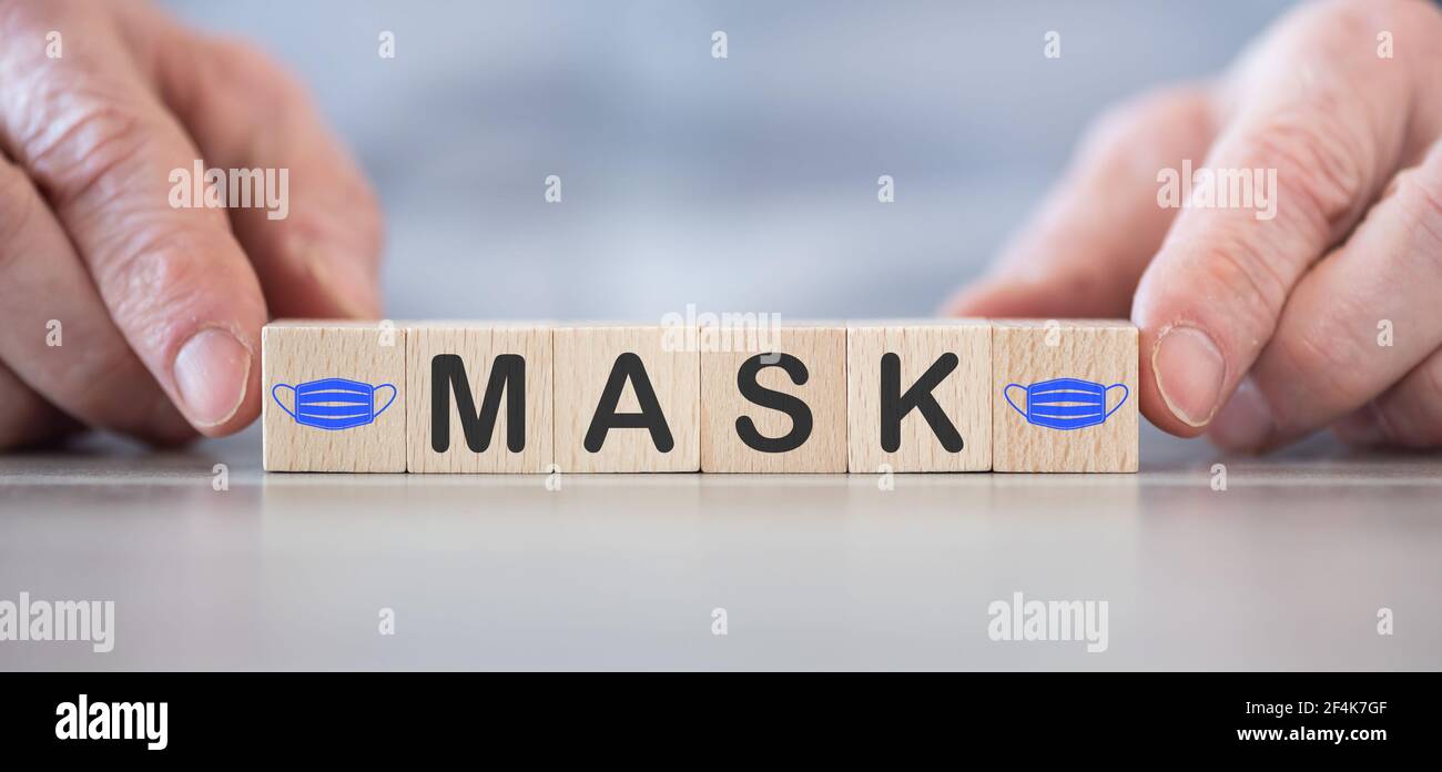 Concept of infection prevention on wooden cubes; wearing a mask Stock ...