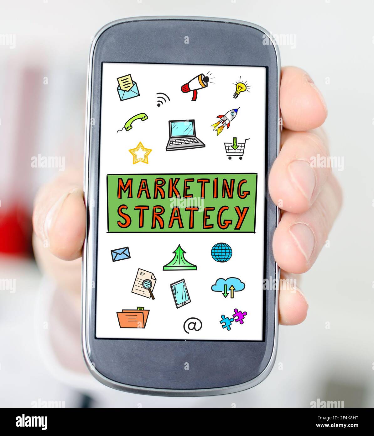 Hand holding a smartphone with marketing strategy concept Stock Photo ...