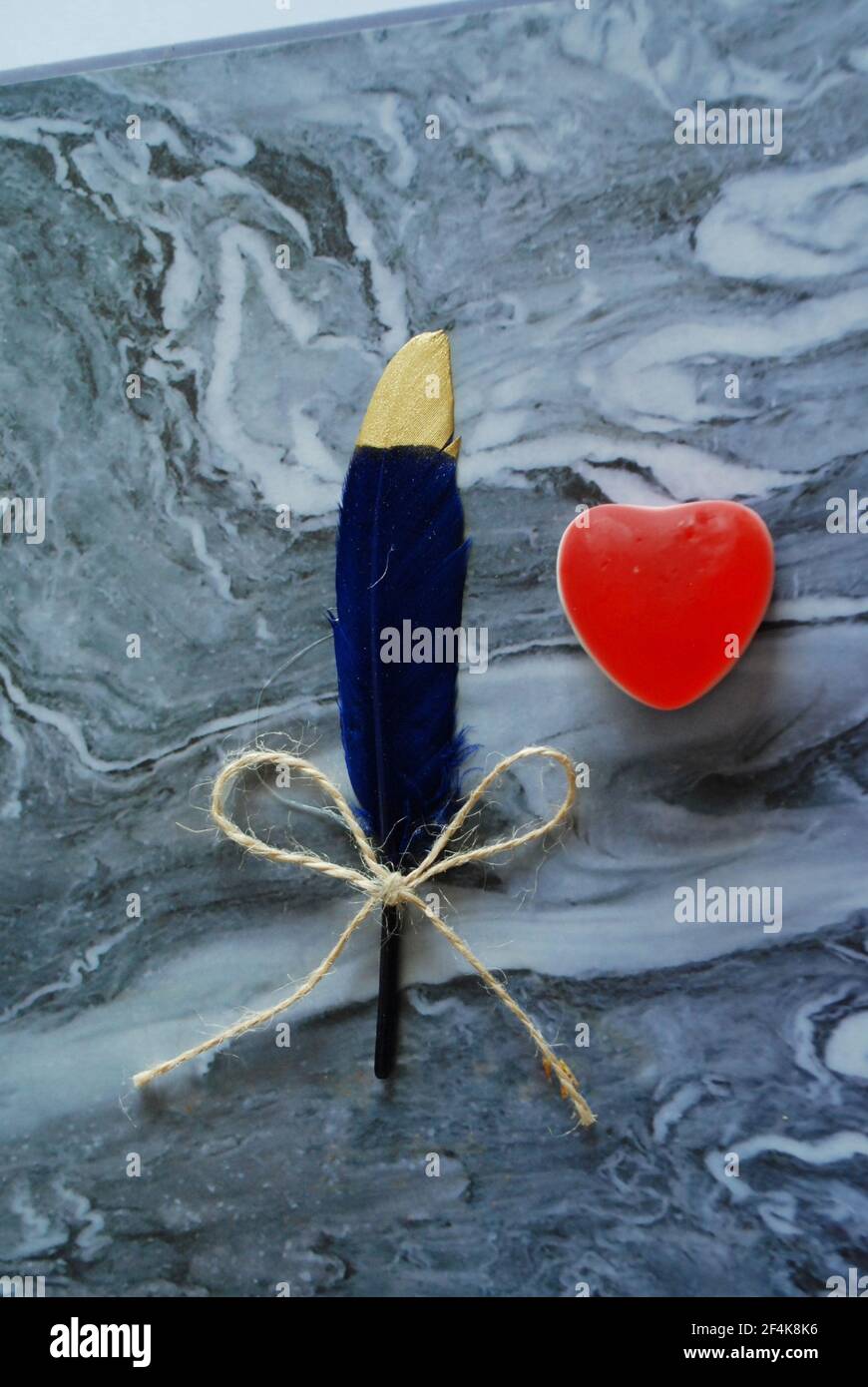 Heart shape red jelly with colorful feather isolated on beautiful ...