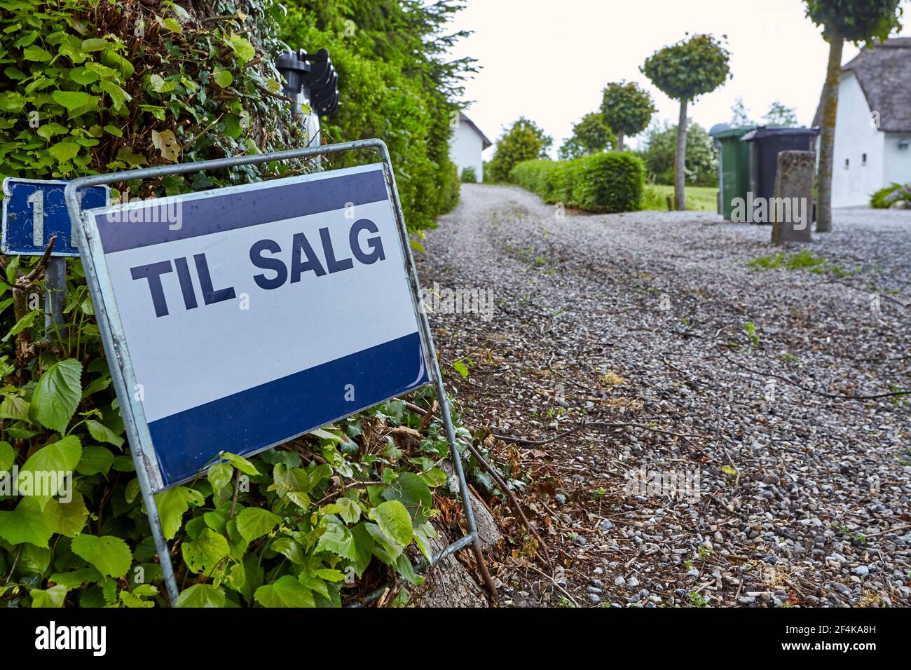 a blue danish for sale sign by a house Stock Photo - Alamy
