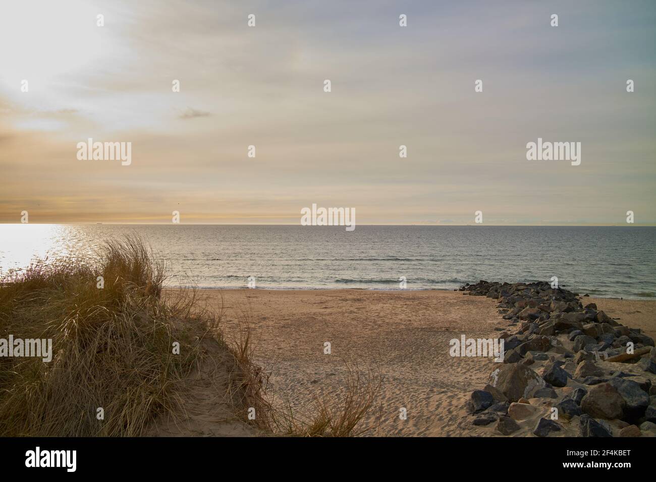 a landscape of the ocean with grass and rocks Stock Photo - Alamy