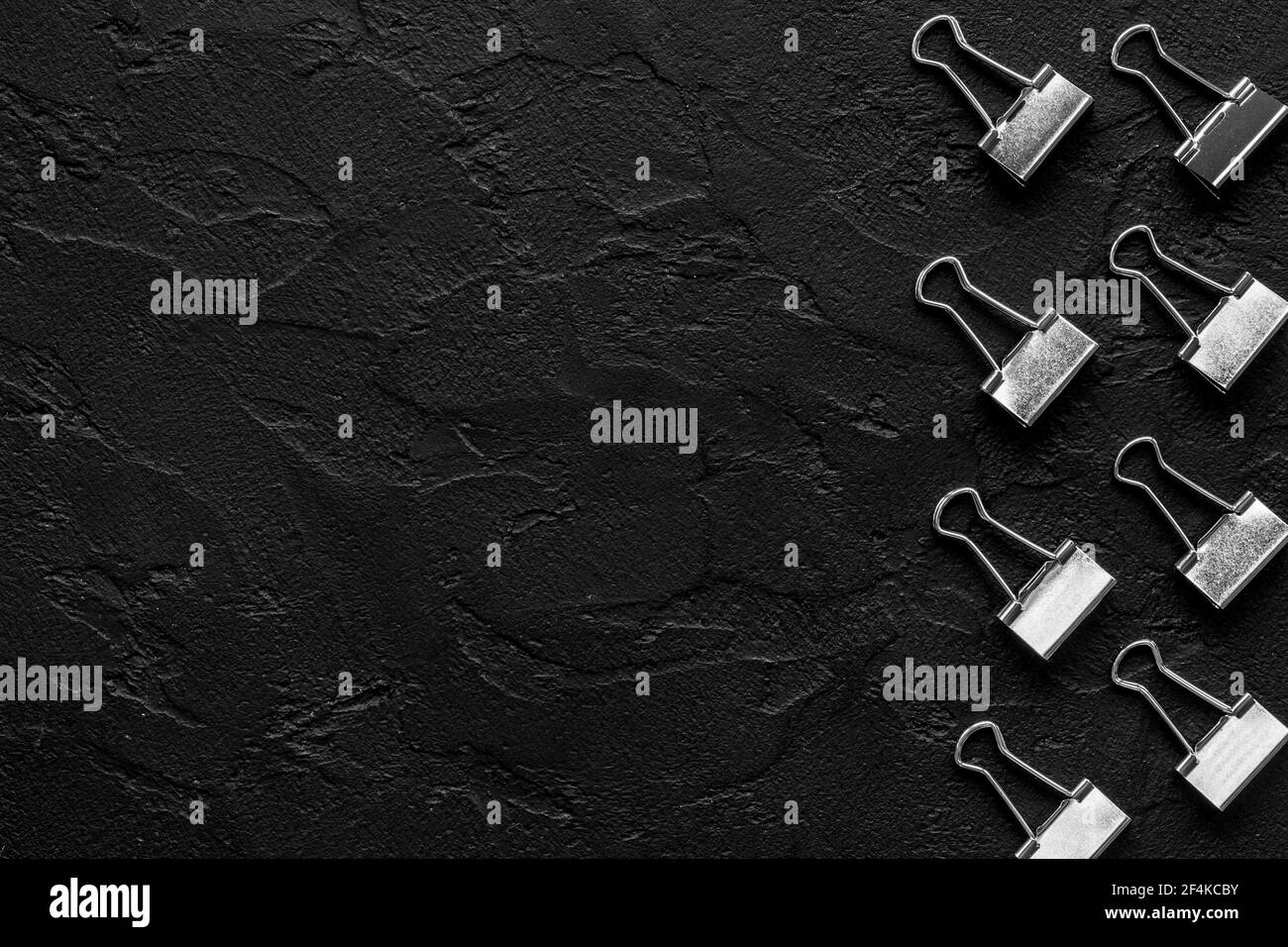 Stationery and office supplies background. Paper binder clips top view ...