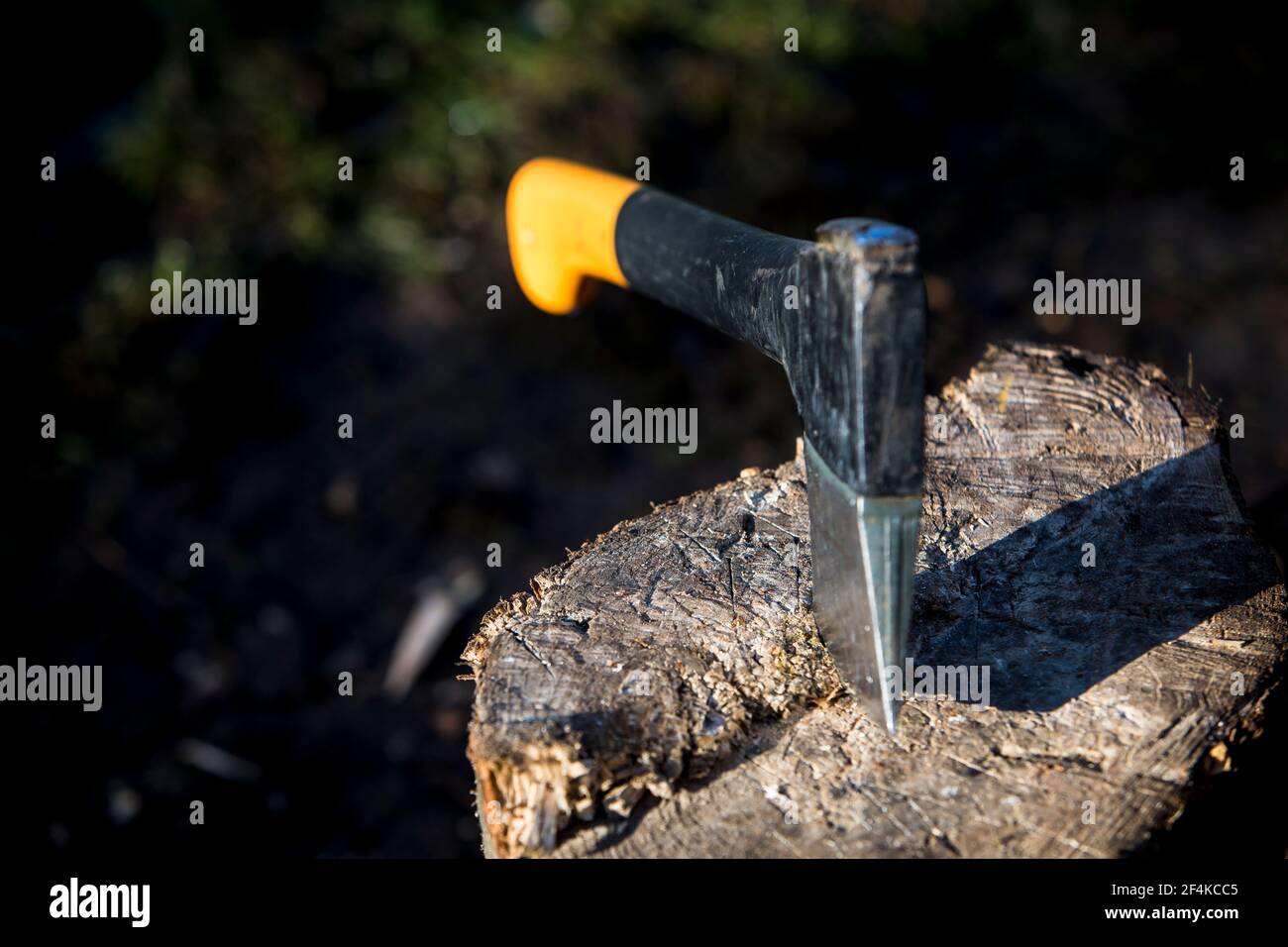 black and yellow axe in wood outdoors Stock Photo - Alamy