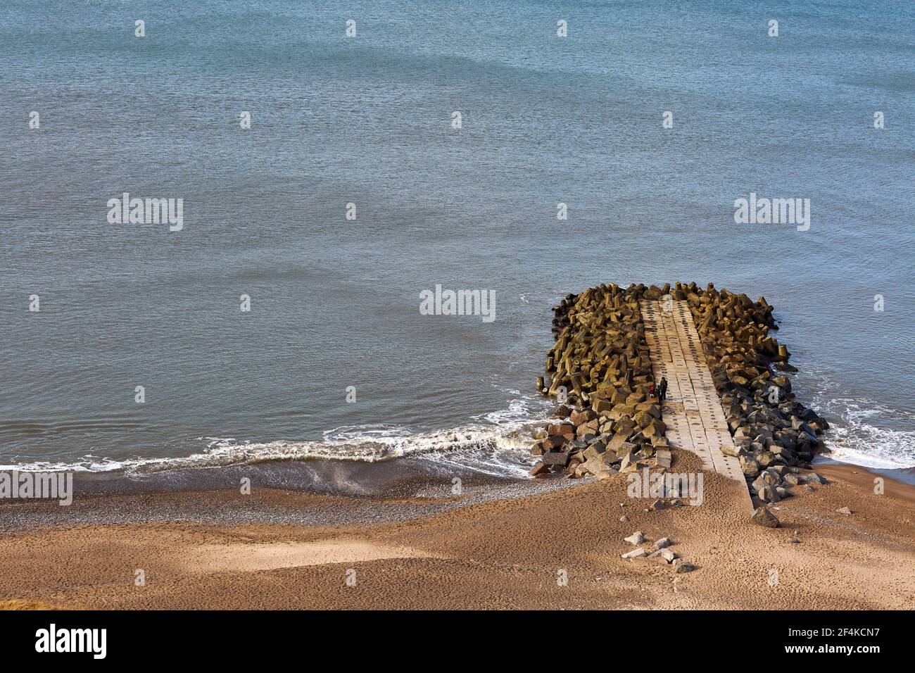 small rock path going out to the water at the beach Stock Photo - Alamy