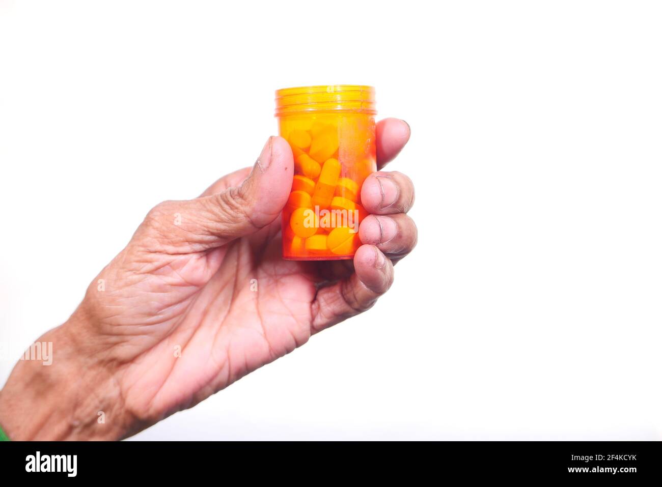 elderly women hand holding pill container isolated on white Stock Photo ...