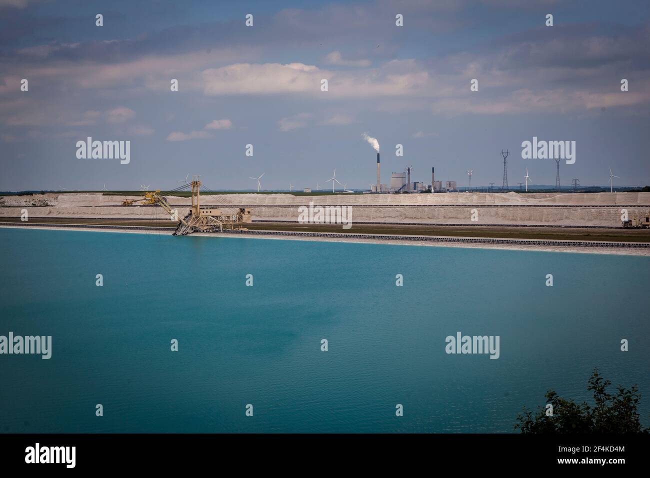 large construction working in a large blue lake Stock Photo - Alamy