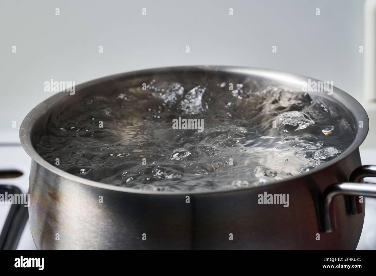 Stainless steel pot with water boiling on the gas stove Stock Photo - Alamy