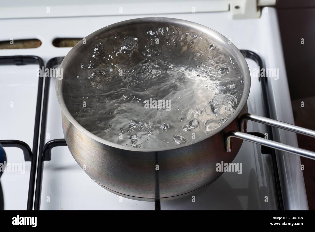 Stainless steel pot with water boiling on the gas stove Stock Photo - Alamy