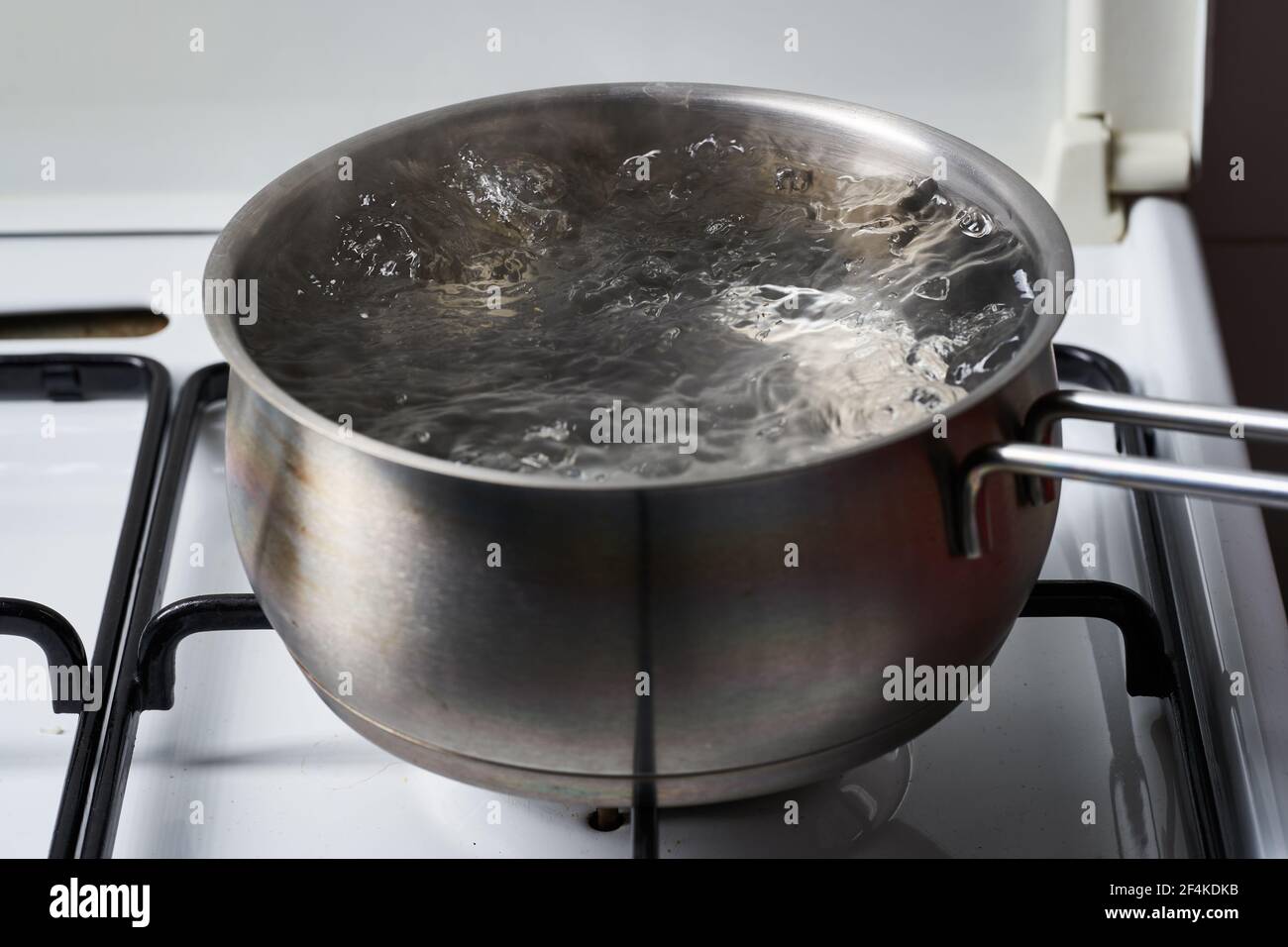 Stainless steel pot with water boiling on the gas stove Stock Photo - Alamy