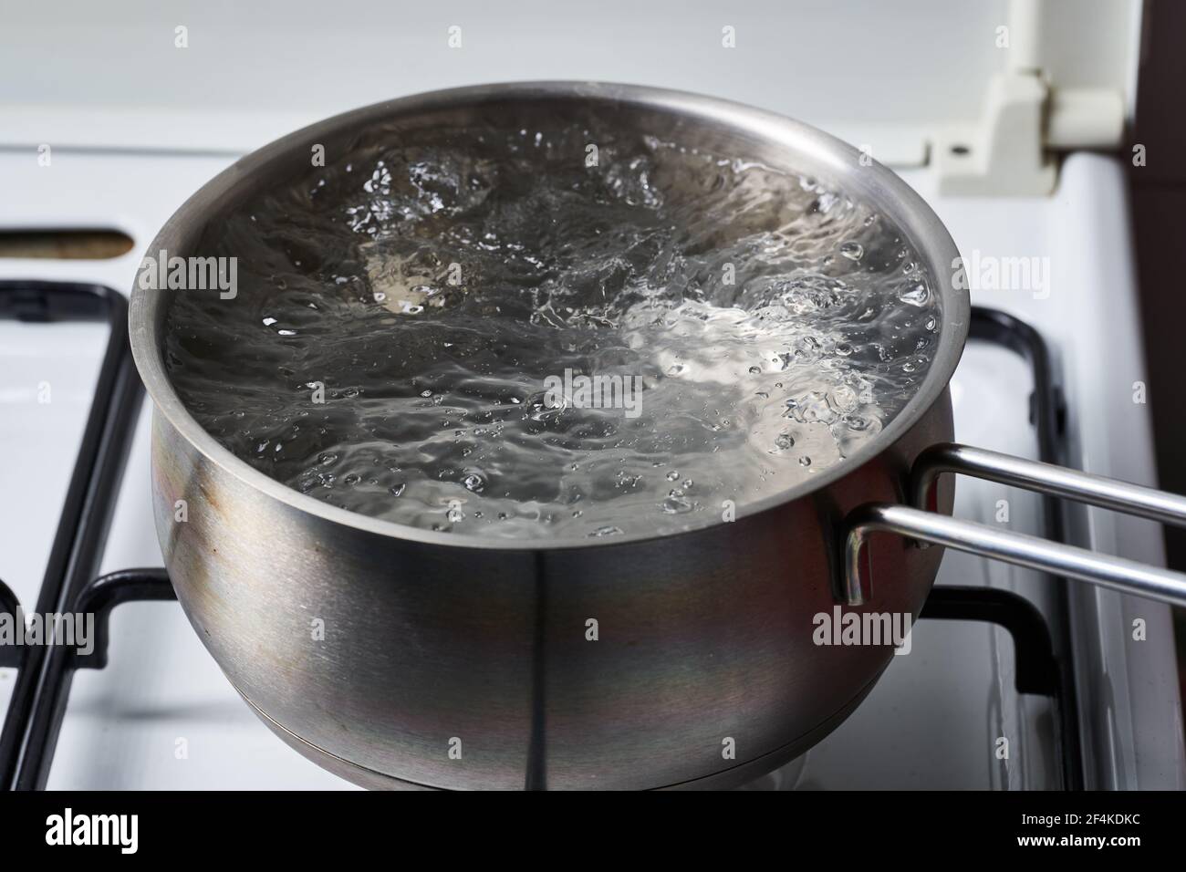 Stainless steel pot with water boiling on the gas stove Stock Photo - Alamy