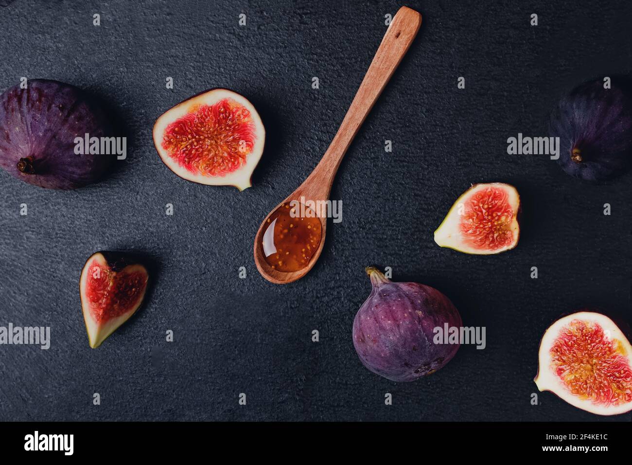 Fig jam and fresh figs on black stone background Stock Photo - Alamy