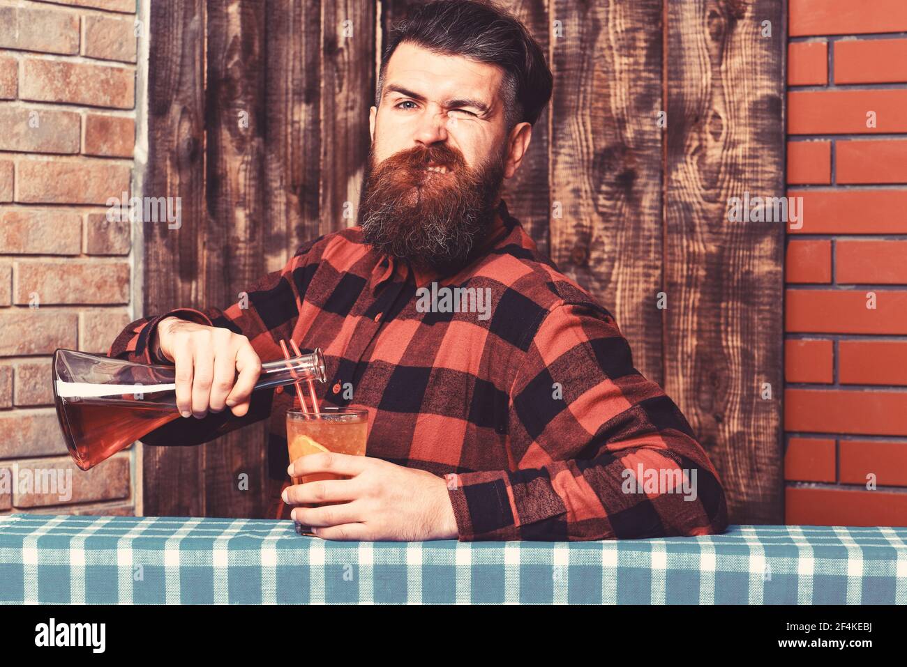 Cheerful bartender concept. Bartender pouring glass and blinking Stock ...