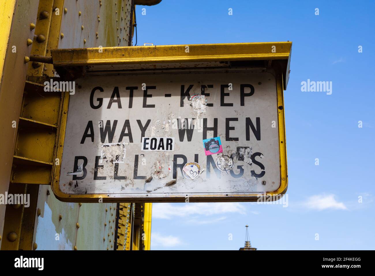 "Gate - keep away when bell rings" sign. The gold painted Tower Bridge ...