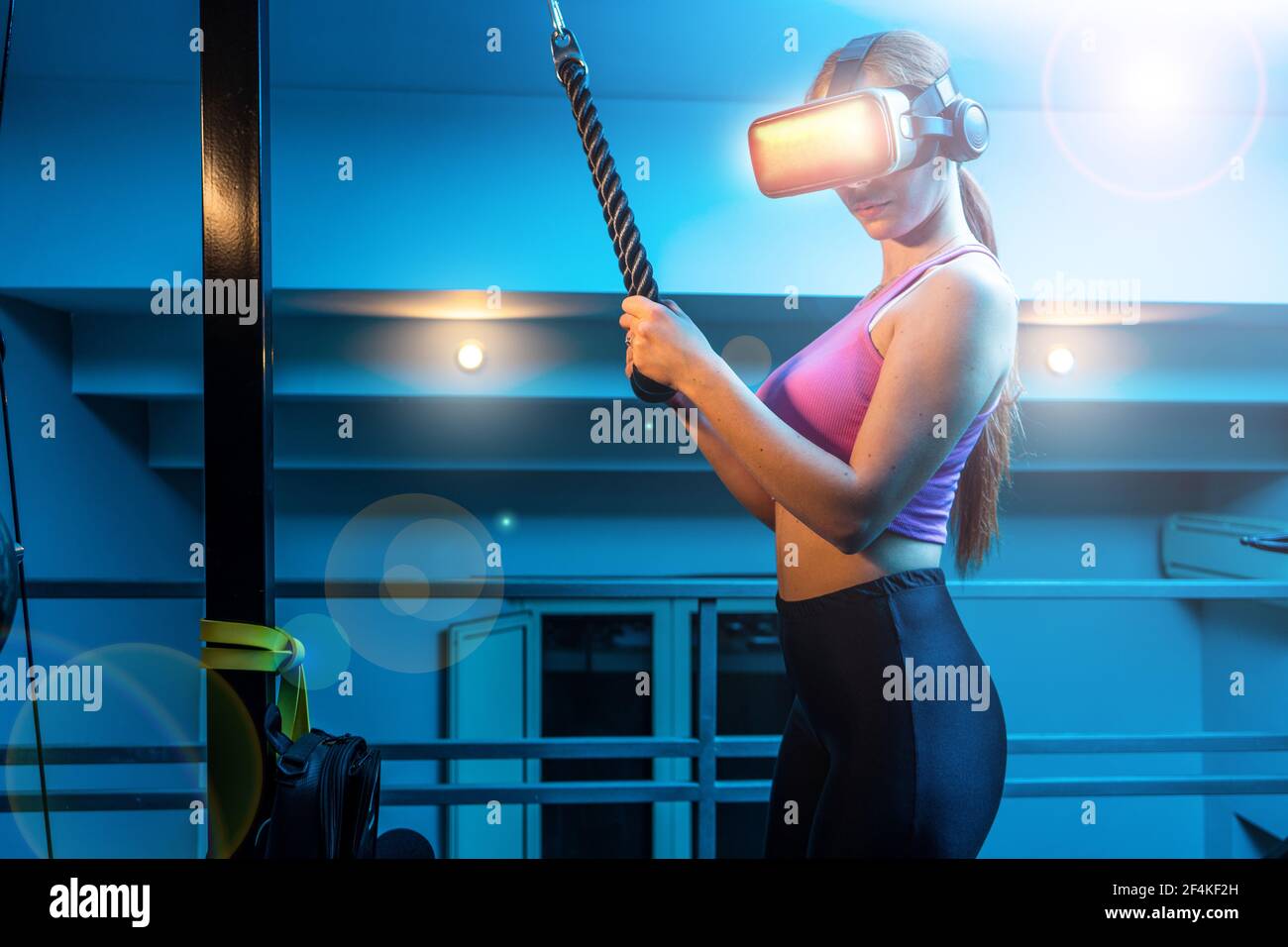 Attractive young red hair sportswoman training triceprs in the gym of ...