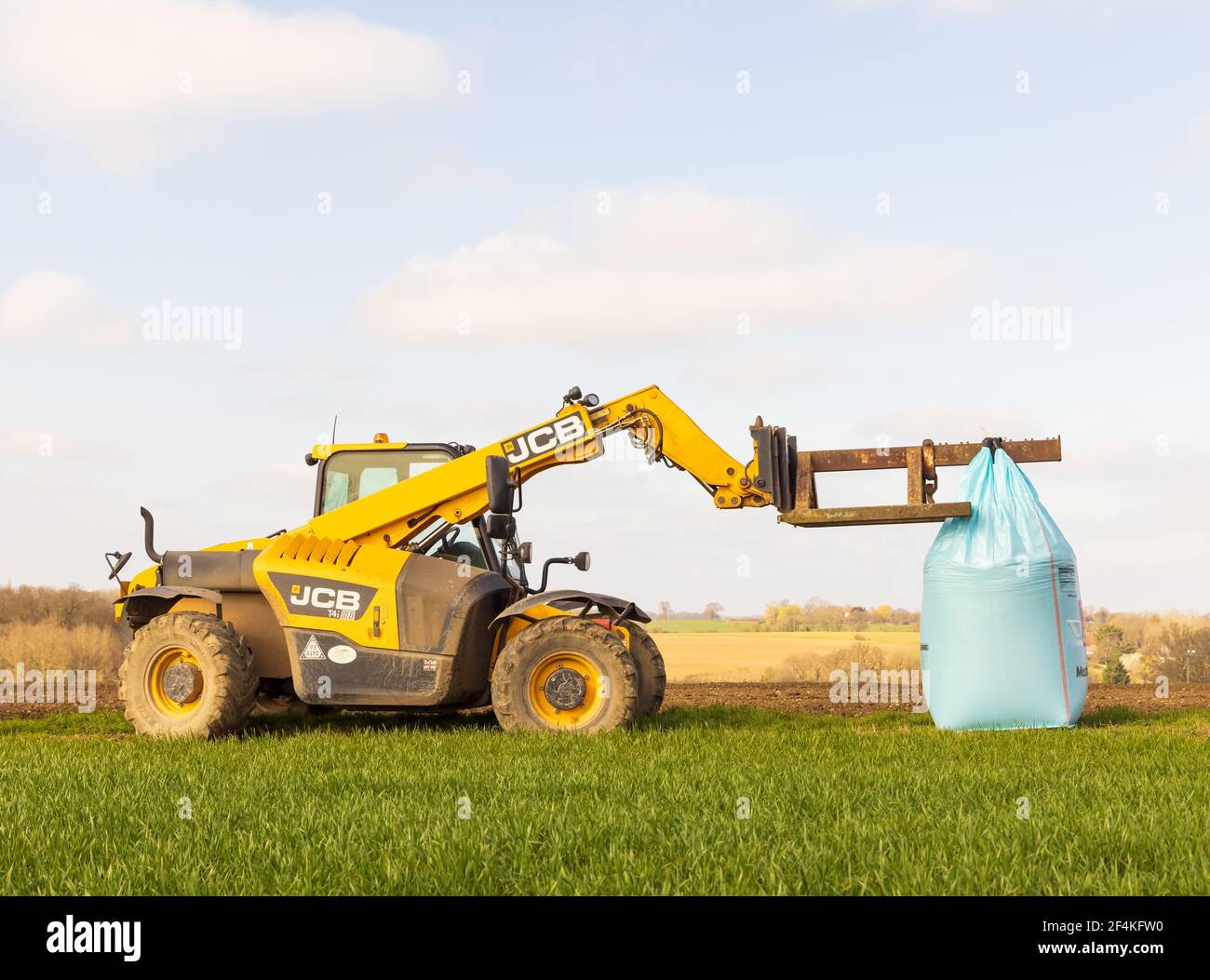 Tractor Telehandler parked in a field carrying a 1000kg bag of spring ...