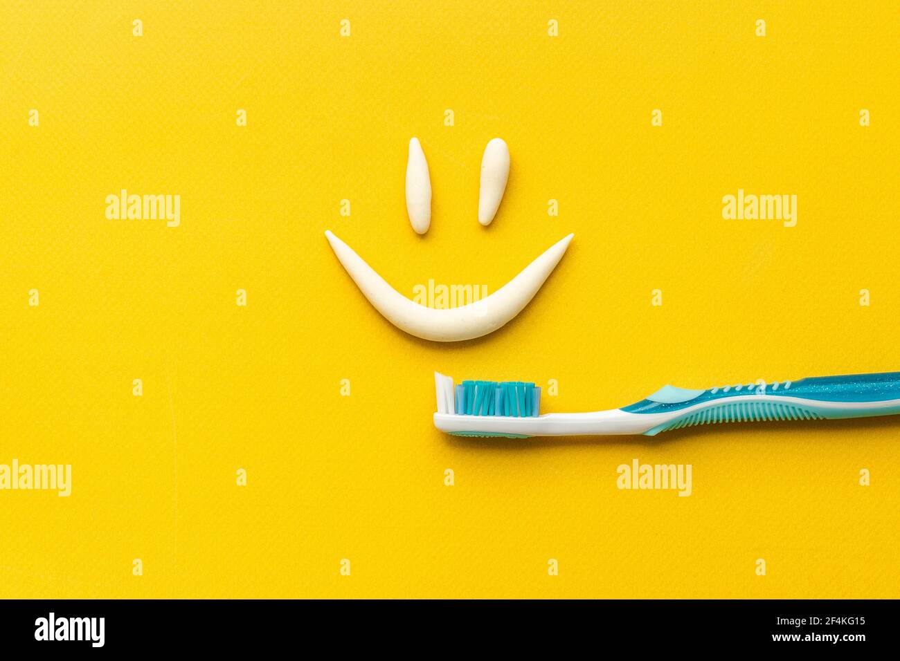 Smile shape of toothpaste with toothbrush, top view. Oral care and ...