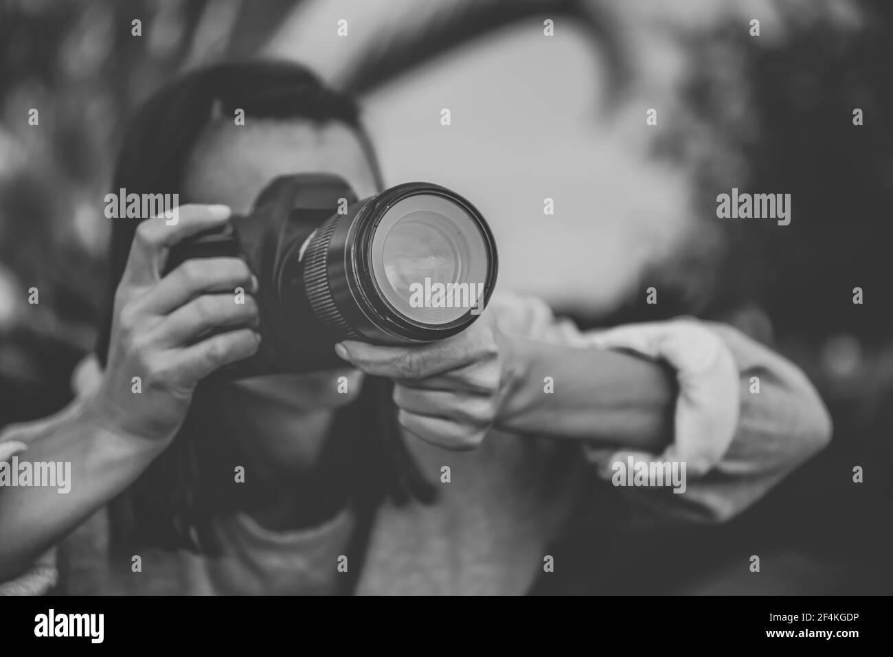 Close up young woman taking pictures outdoors on a professional SLR ...