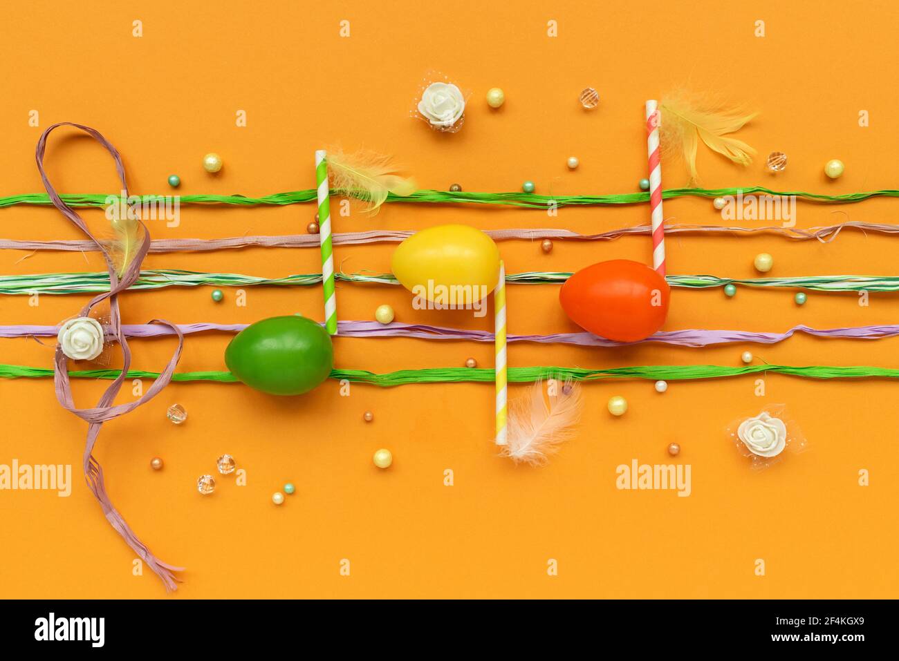 Musical notes make from Easter eggs on yellow background. Easter ...