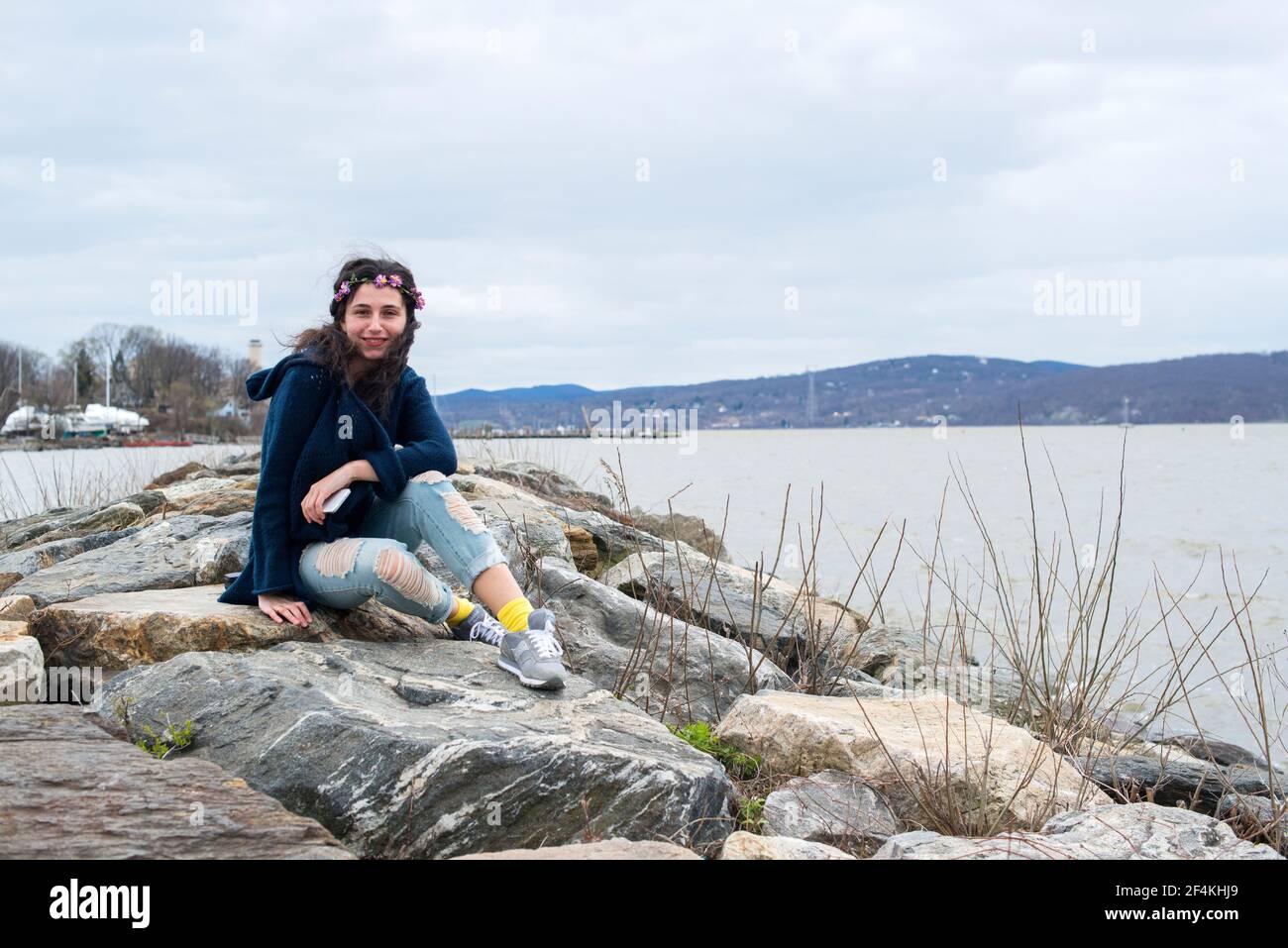 Peekskill, New York, USA. Portrait of a young, teenage gil sitting at a ...