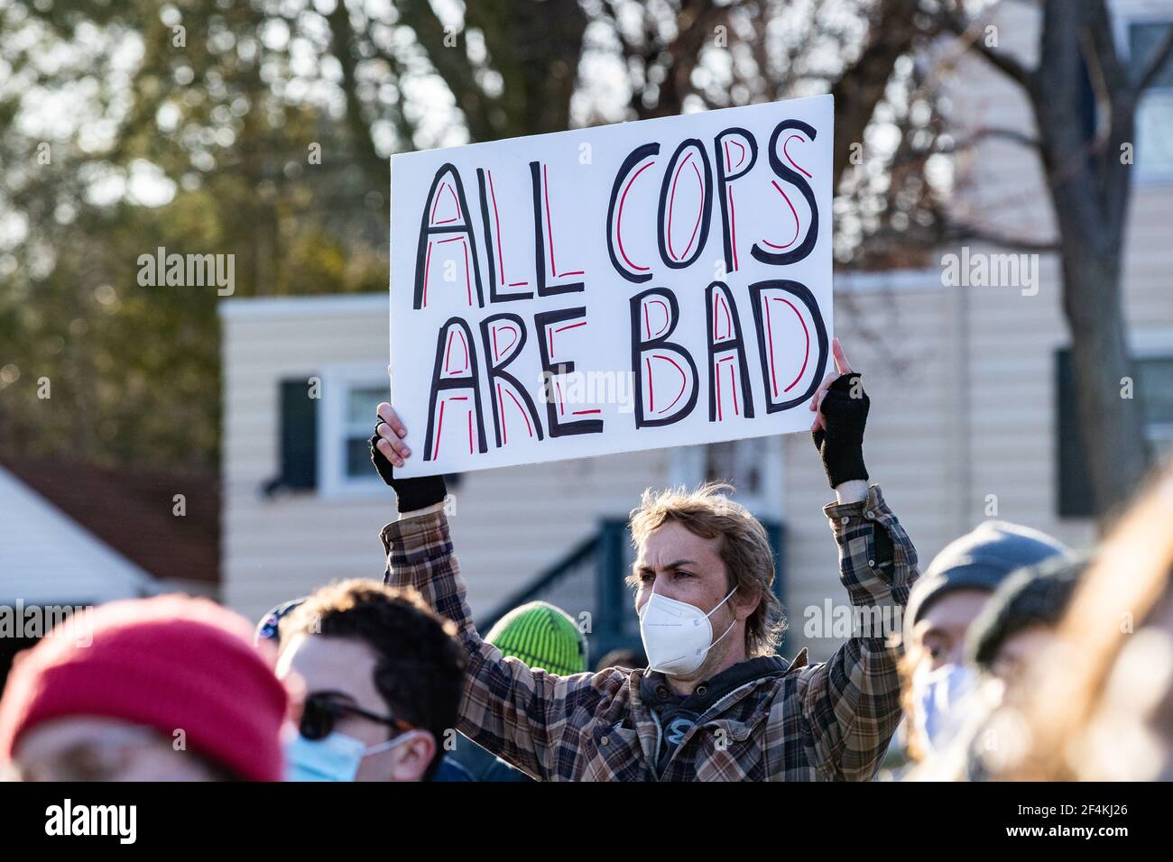 A protester holds a placard reading "all cops are bad." during a ...