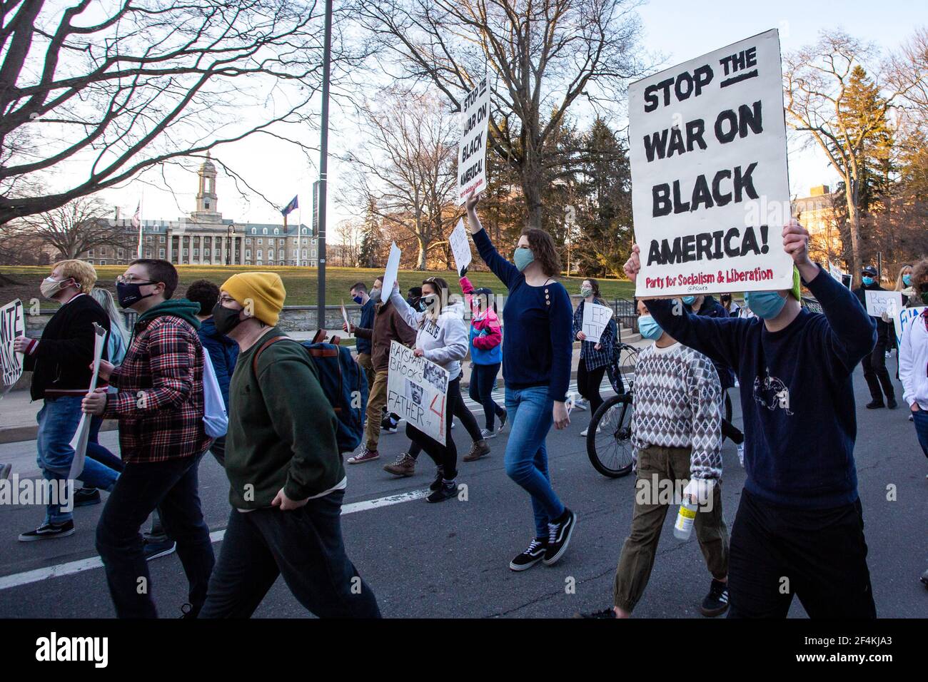 Protesters marching past Penn State's Old Main during a protest march ...