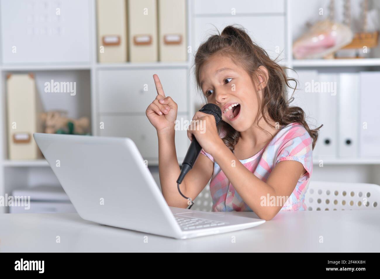 Emotional cute girl using laptop has an idea Stock Photo - Alamy