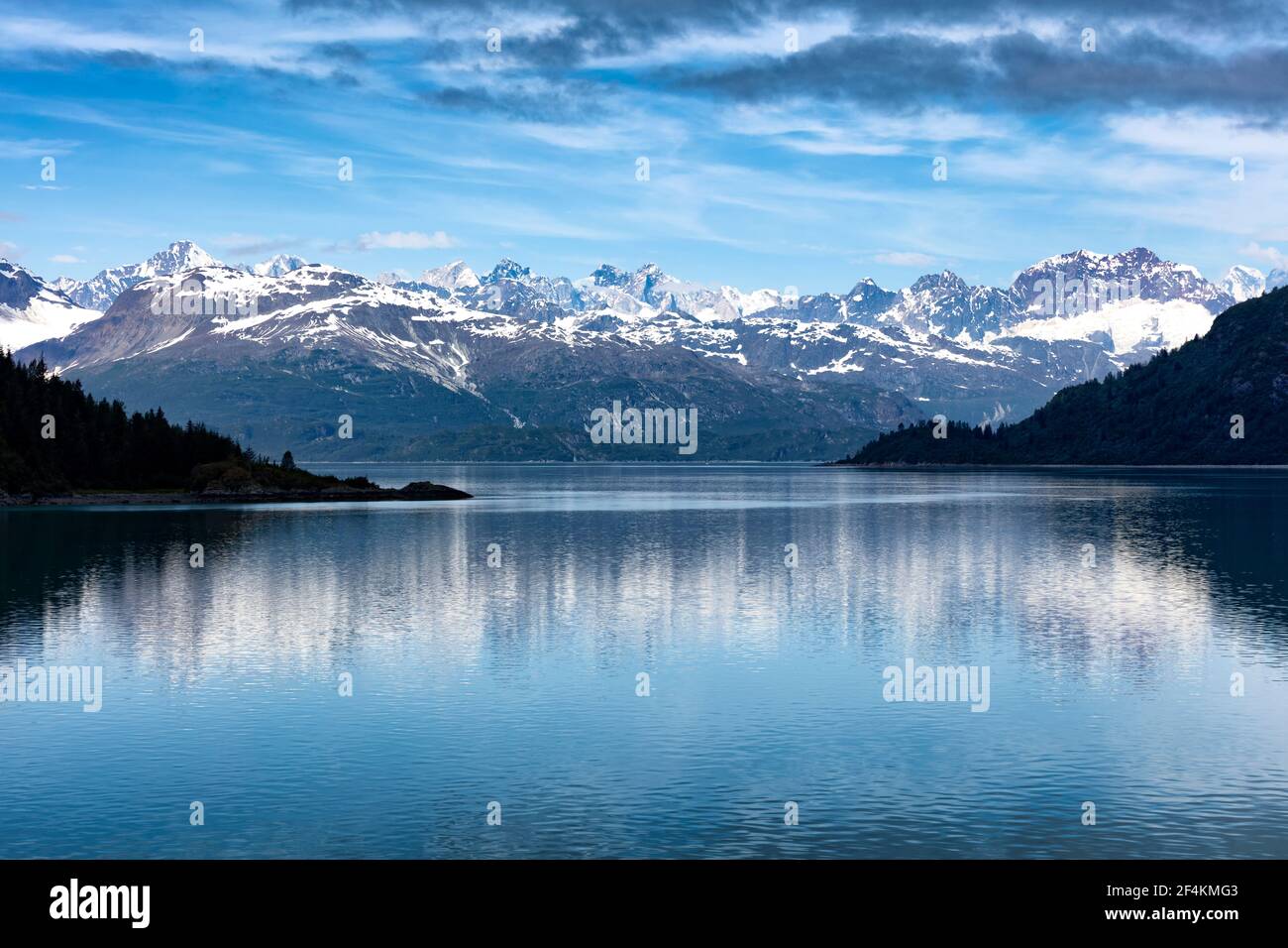 Wide view of Alaska Glacier bay during summer time. Clouds and blue sky ...