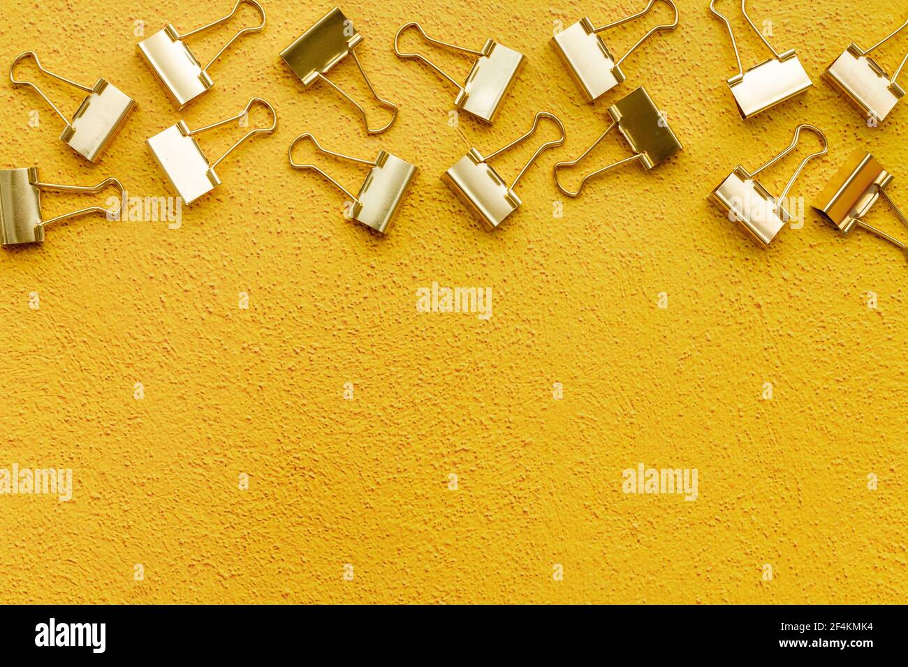 Office supplies background - paper binder clips top view Stock Photo ...